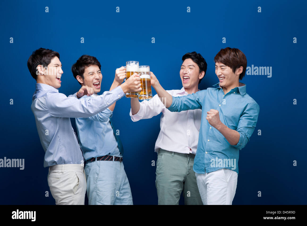 four businessmen toasting with beer Stock Photo - Alamy
