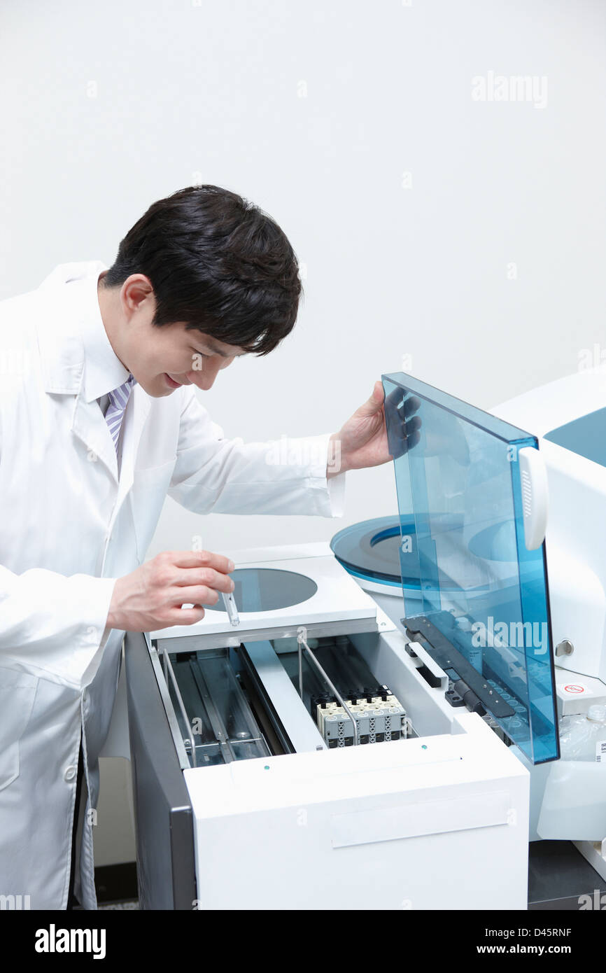 a doctor checking on a medical device Stock Photo - Alamy