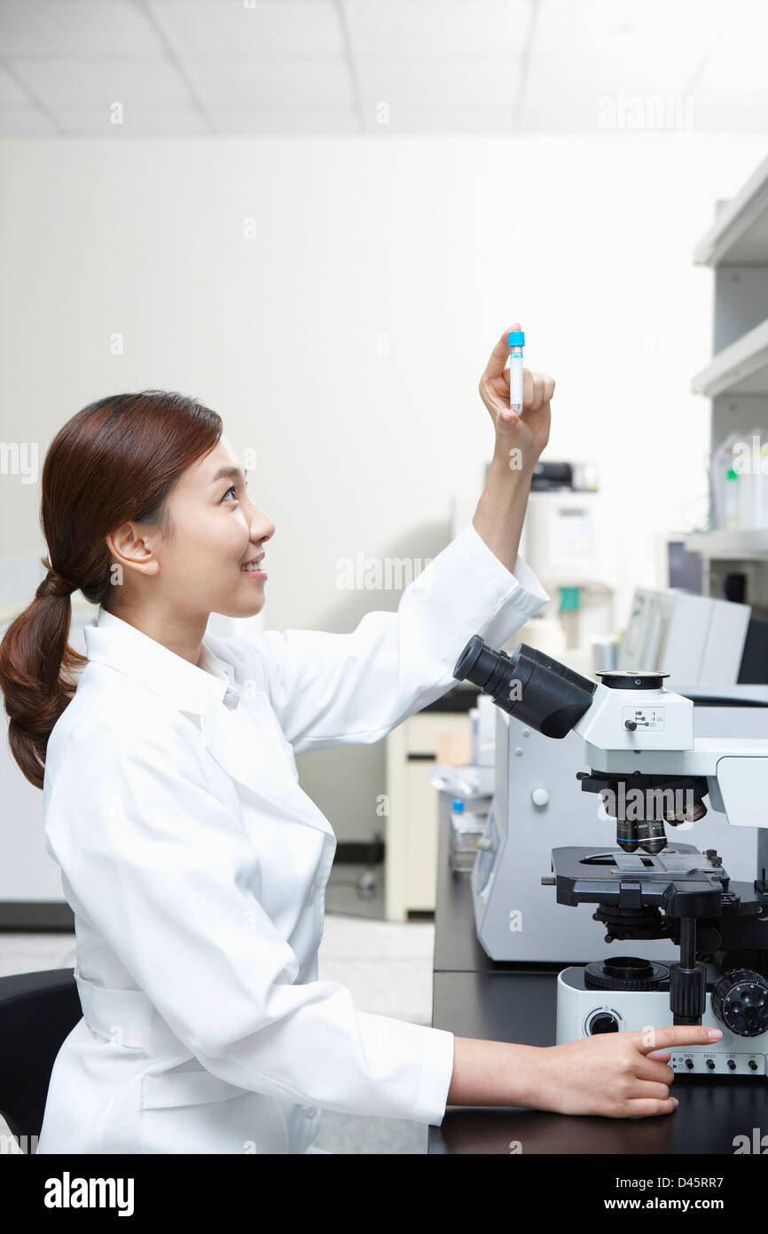 a female doctor holding a sample tube Stock Photo - Alamy