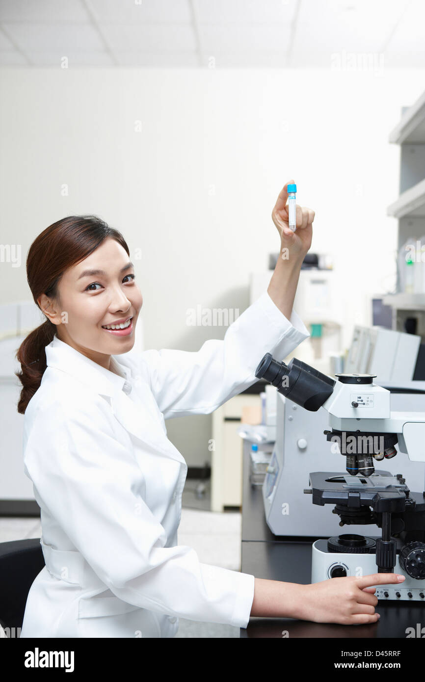 a female doctor holding a sample tube Stock Photo - Alamy