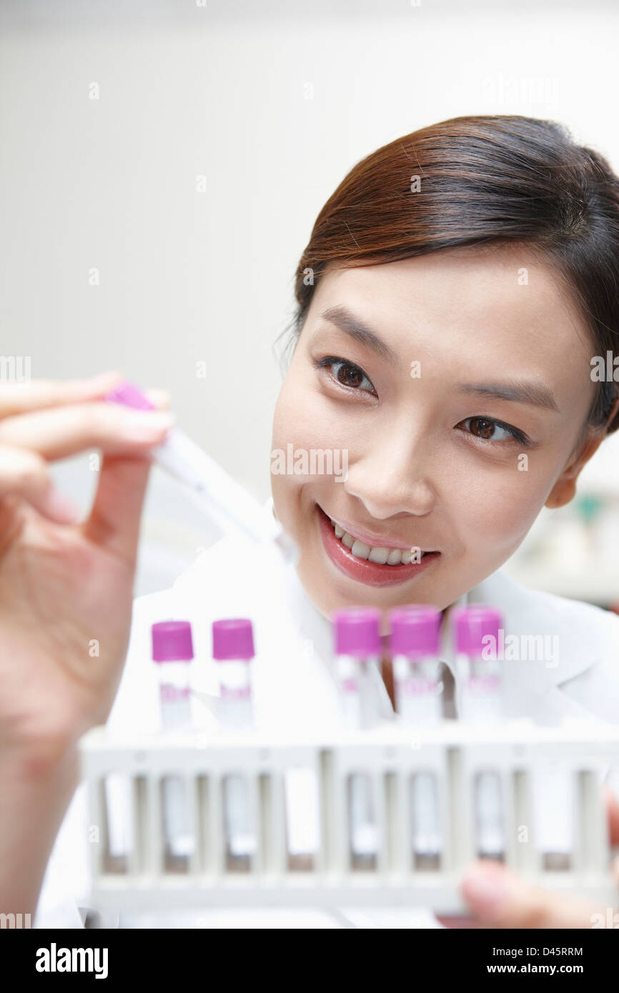 a female doctor putting a sample tube in the case Stock Photo - Alamy