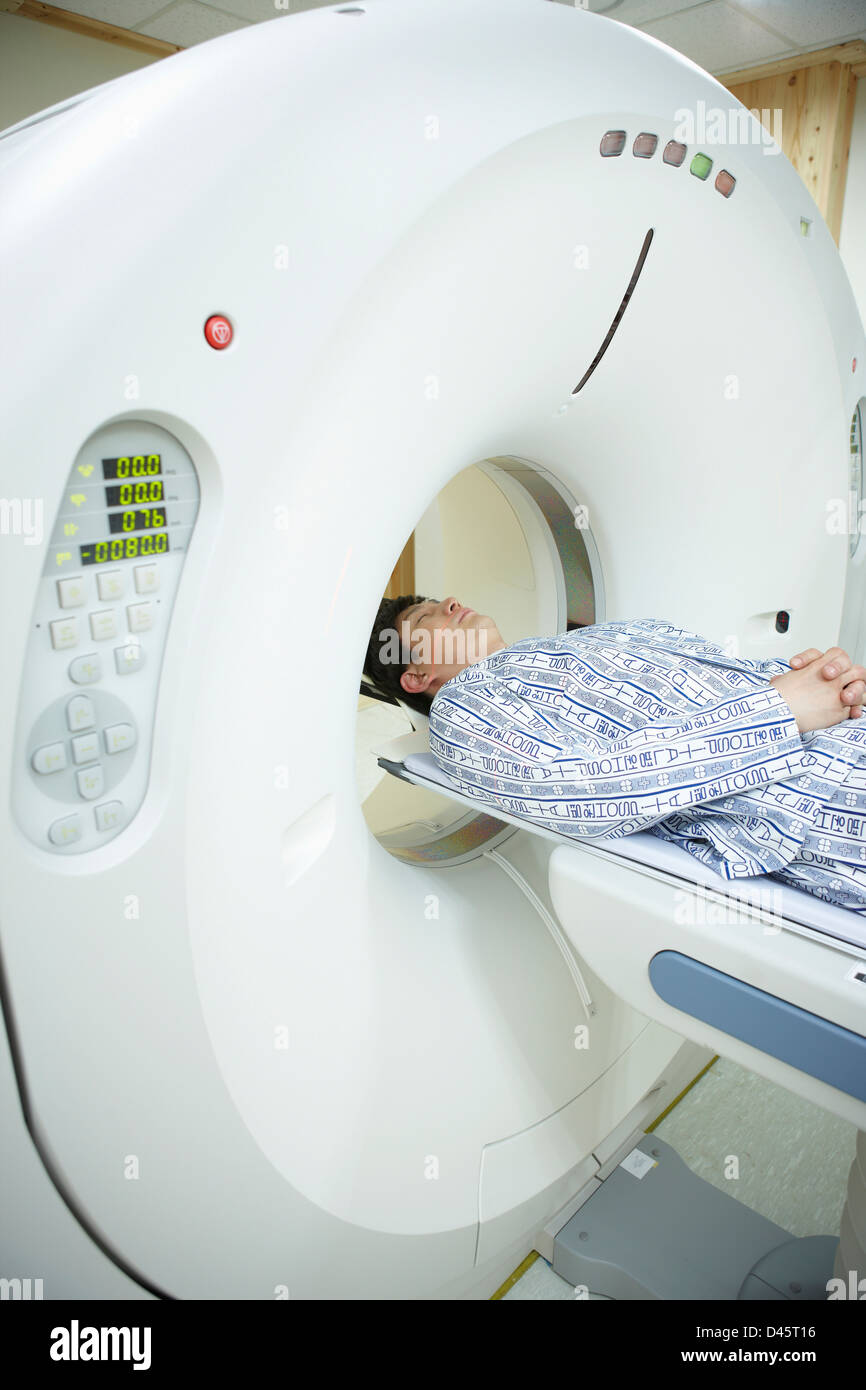 a patient going through a CT scanner Stock Photo - Alamy