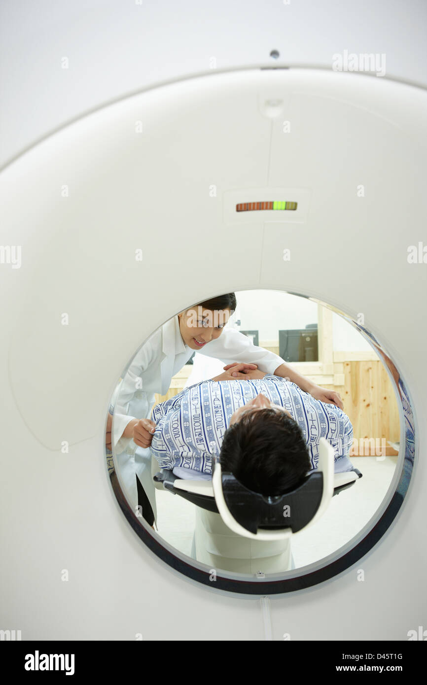a patient going through a CT scanner Stock Photo - Alamy