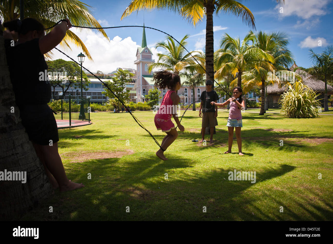 Kids skipping rope in the park, Papeete Stock Photo - Alamy