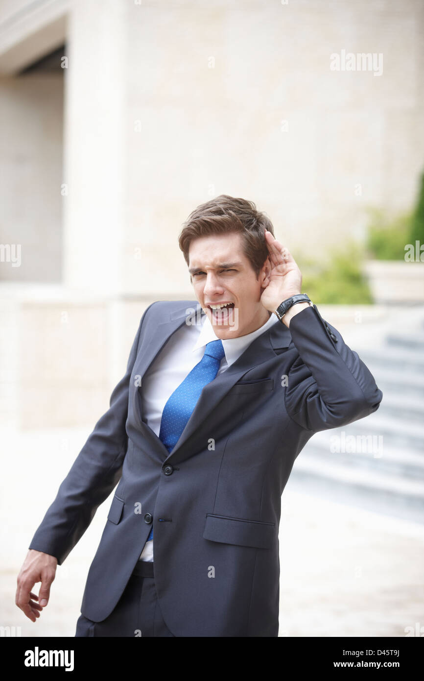 a western businessman with can not hear pose Stock Photo - Alamy