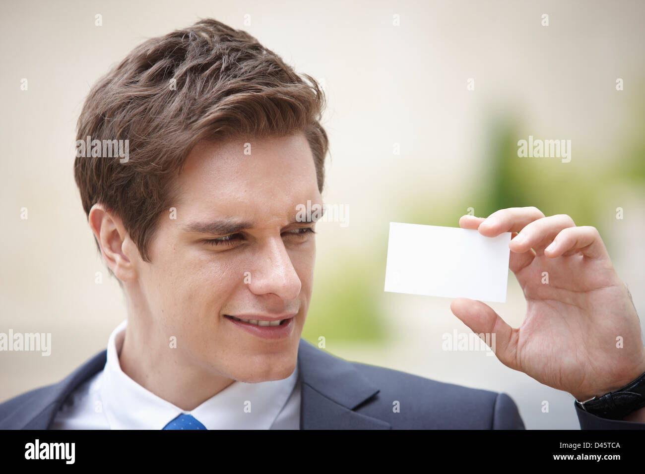 a western businessman holding a business card Stock Photo - Alamy