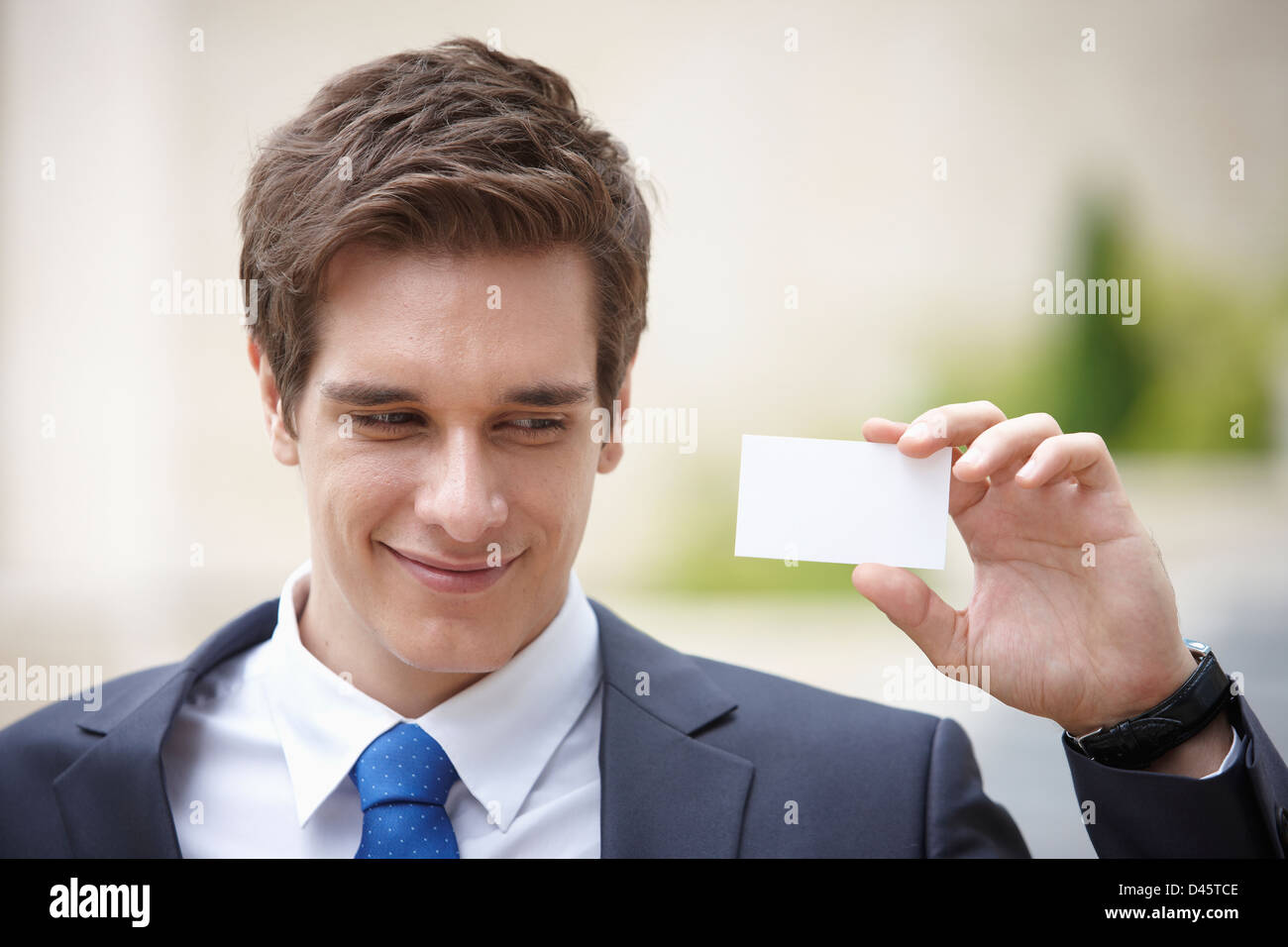 a western businessman holding a business card Stock Photo - Alamy