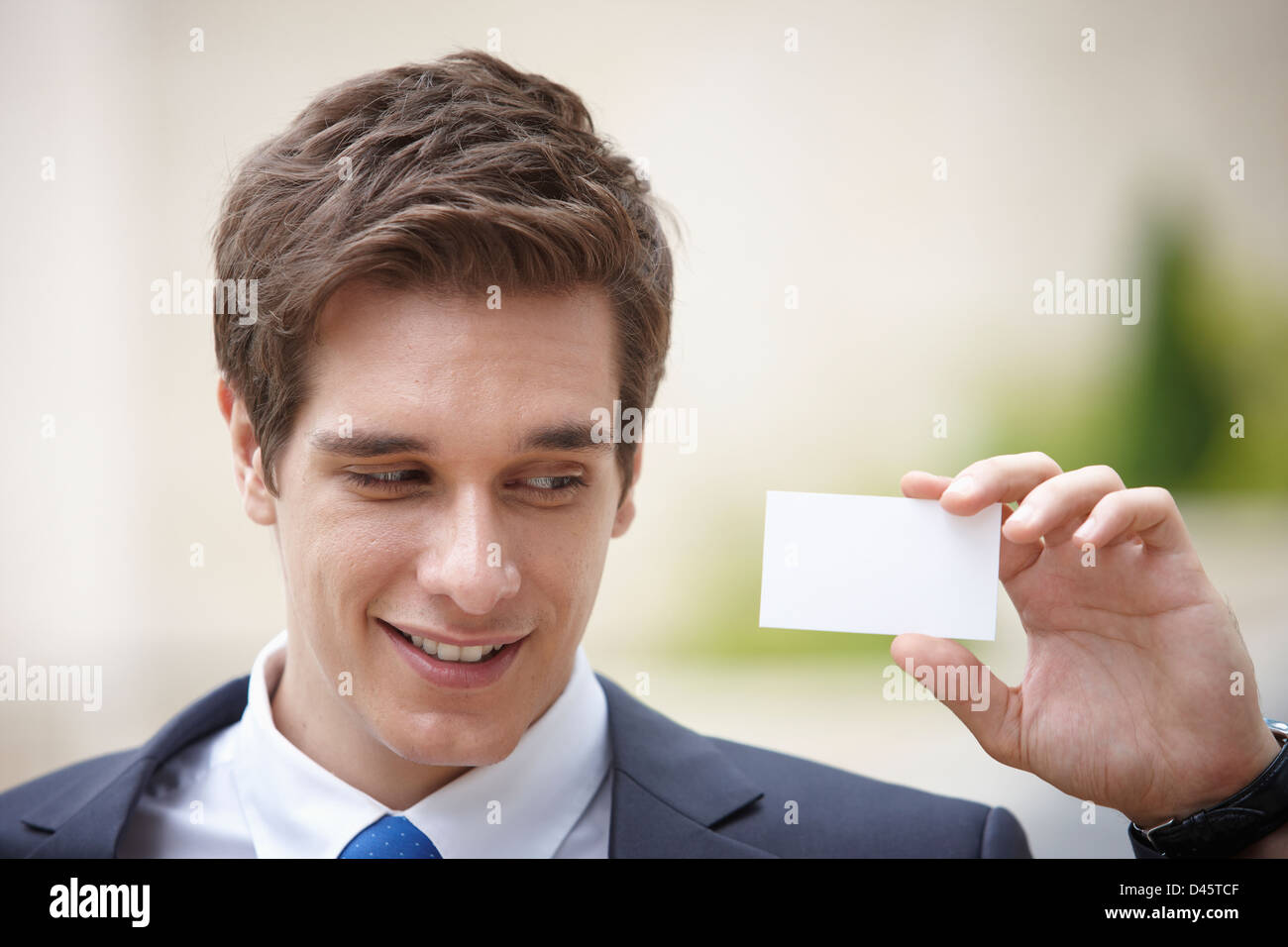 a western businessman holding a business card Stock Photo - Alamy