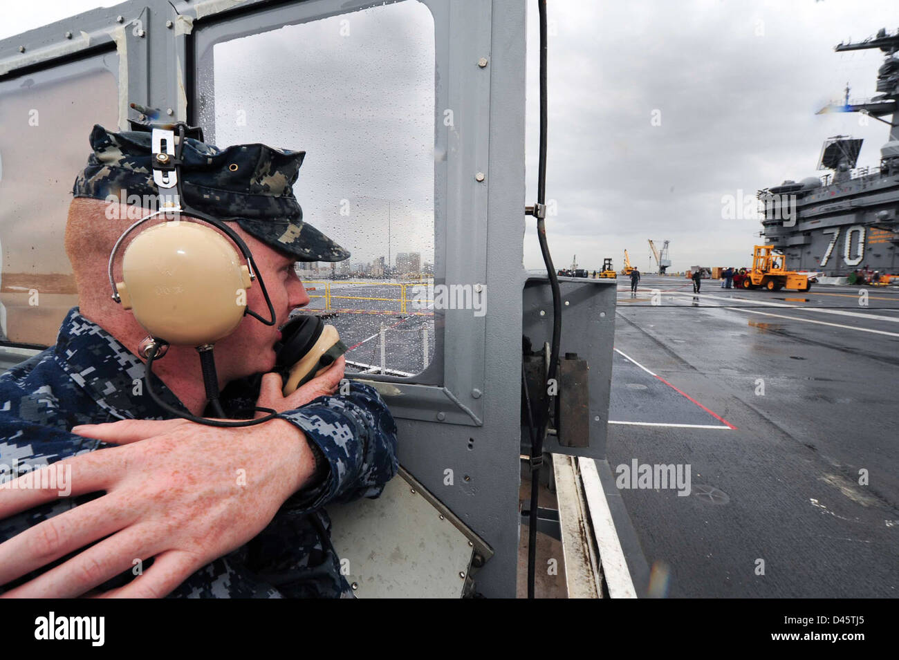 A U.S. Navy sailor communicates using a sound-powered phone in ...