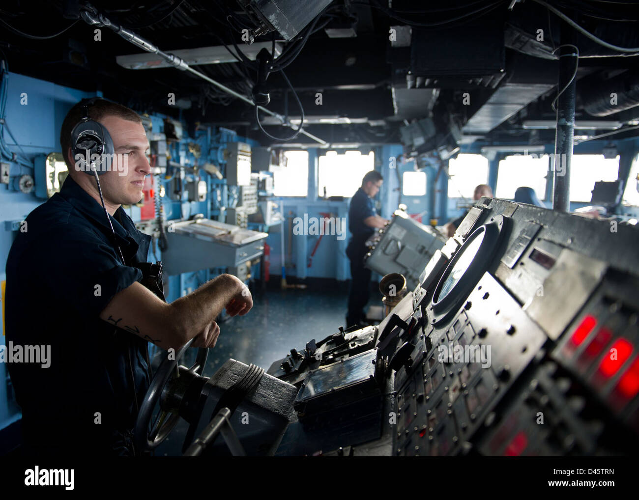 A Sailor aboard the USS Tortuga navigates the South China Sea, ensuring ...