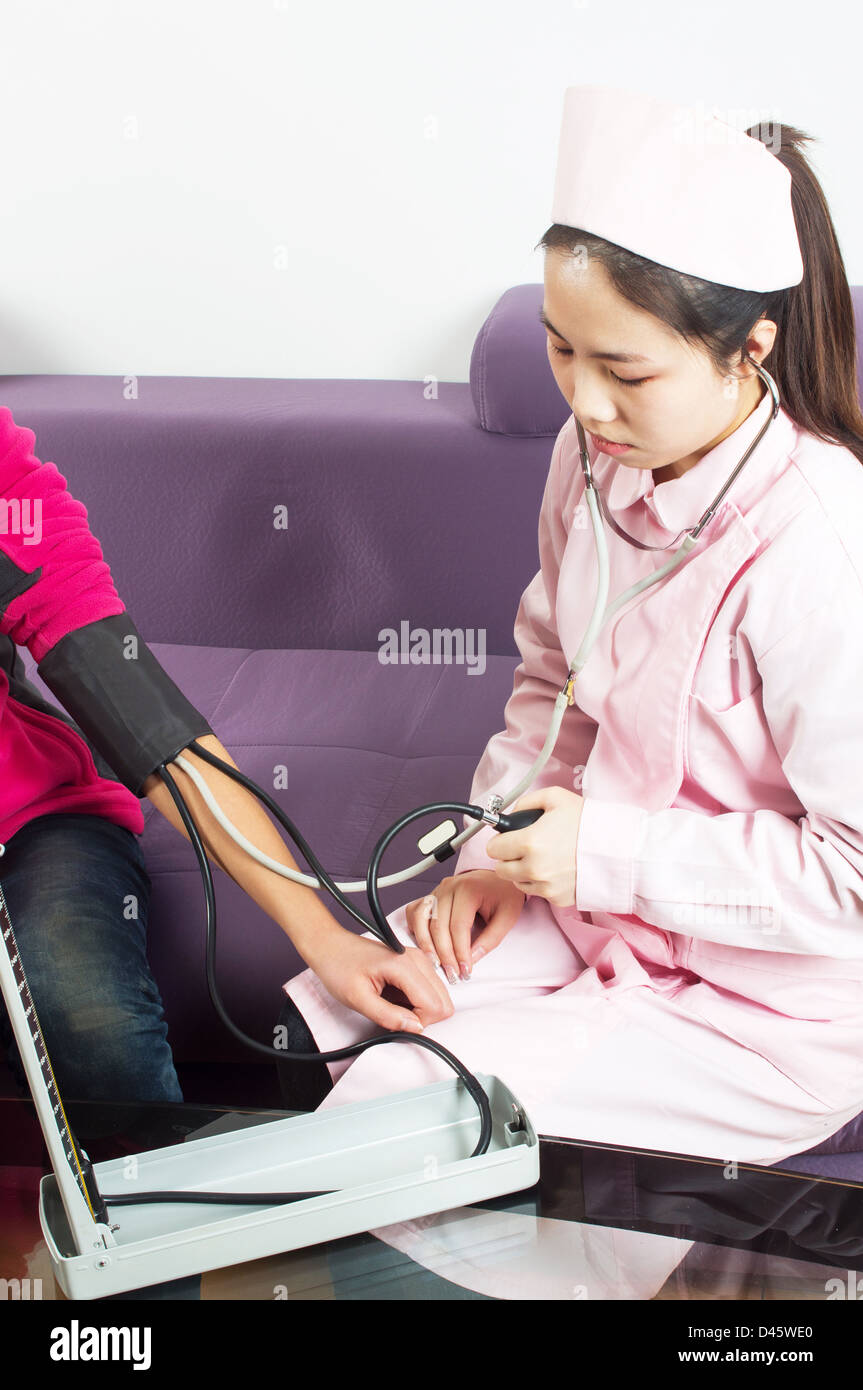 The nurses are measuring blood pressure Stock Photo - Alamy