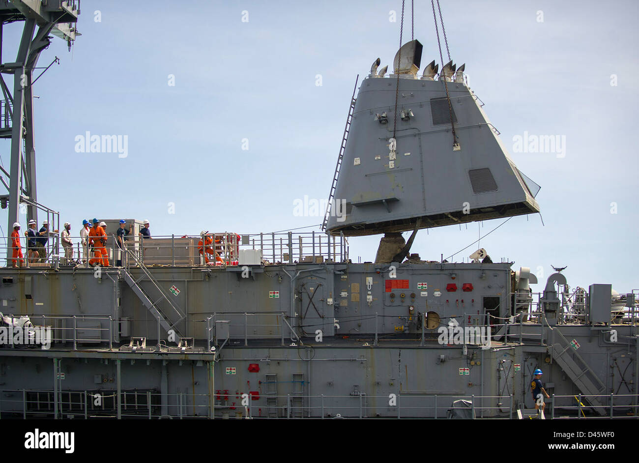 Sailors aboard USS Guardian perform maintenance, removing the exhaust ...