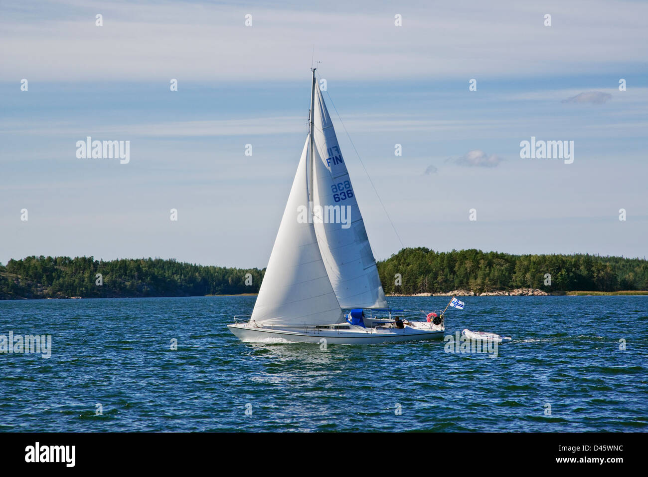 Finland, Turku Archipelago, sailing boat in the narrow between ...