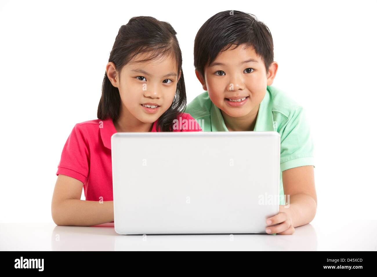 Studio Shot Of Two Chinese Children With Laptop Stock Photo - Alamy
