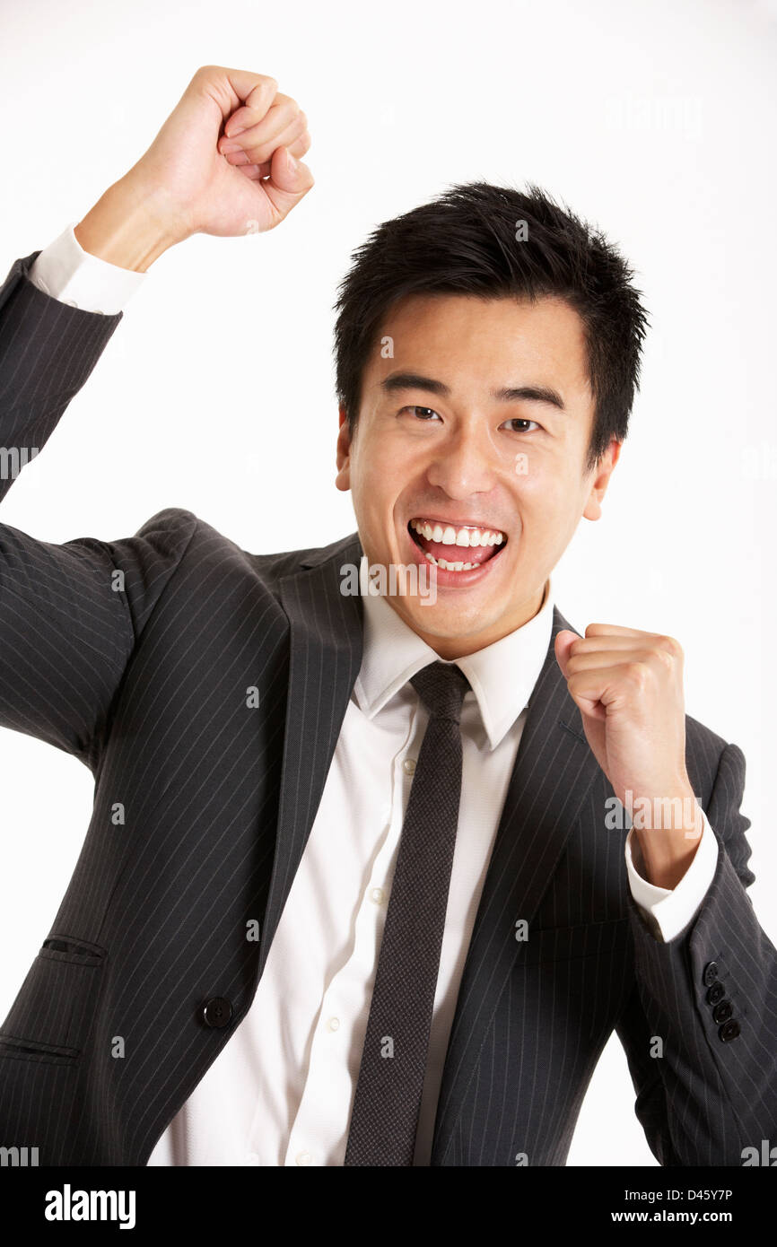 Studio Portrait Of Chinese Businessman Celebrating Stock Photo - Alamy