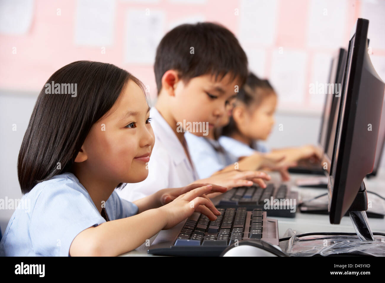 Female Pupil Using Keyboard During Computer Class In Chinese School ...