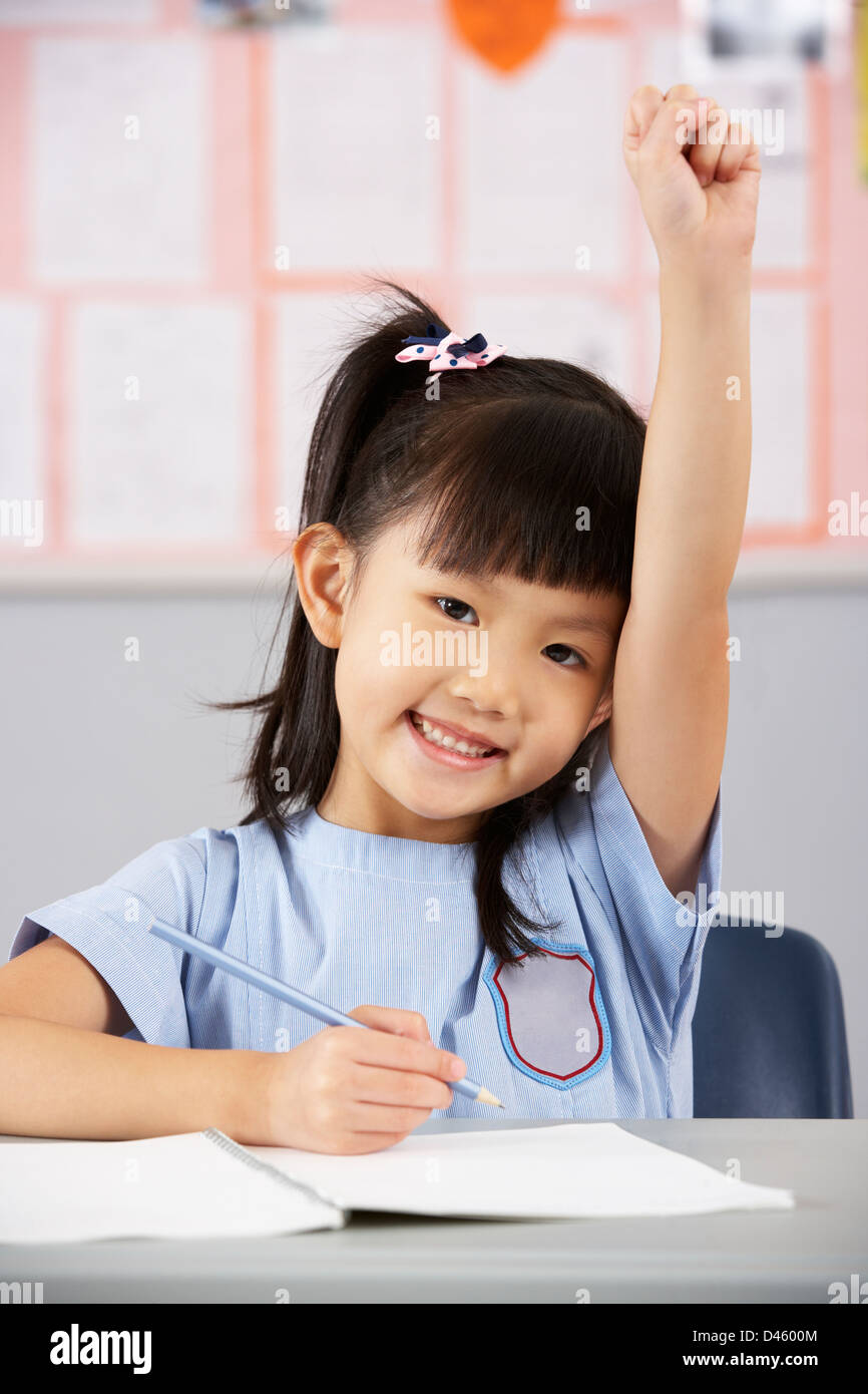 School desk hand raised uniform hi-res stock photography and images - Alamy