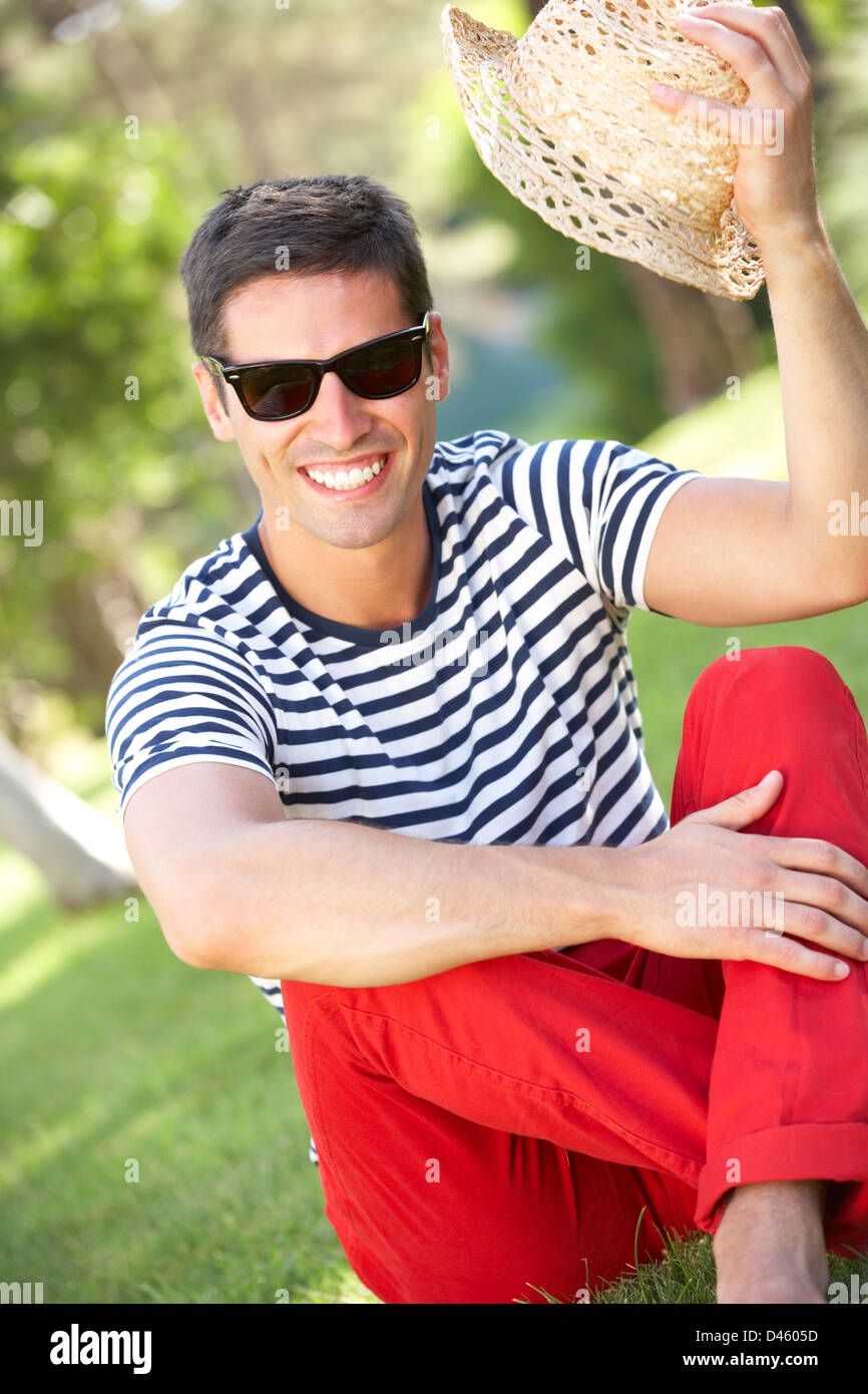 Man Relaxing In Summer Garden Stock Photo - Alamy