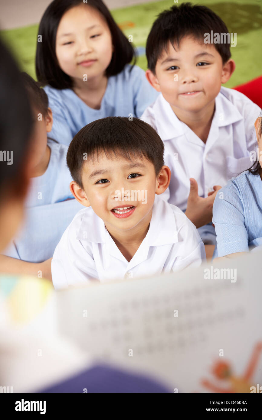 Teacher Reading To Students In Chinese School Classroom Stock Photo - Alamy