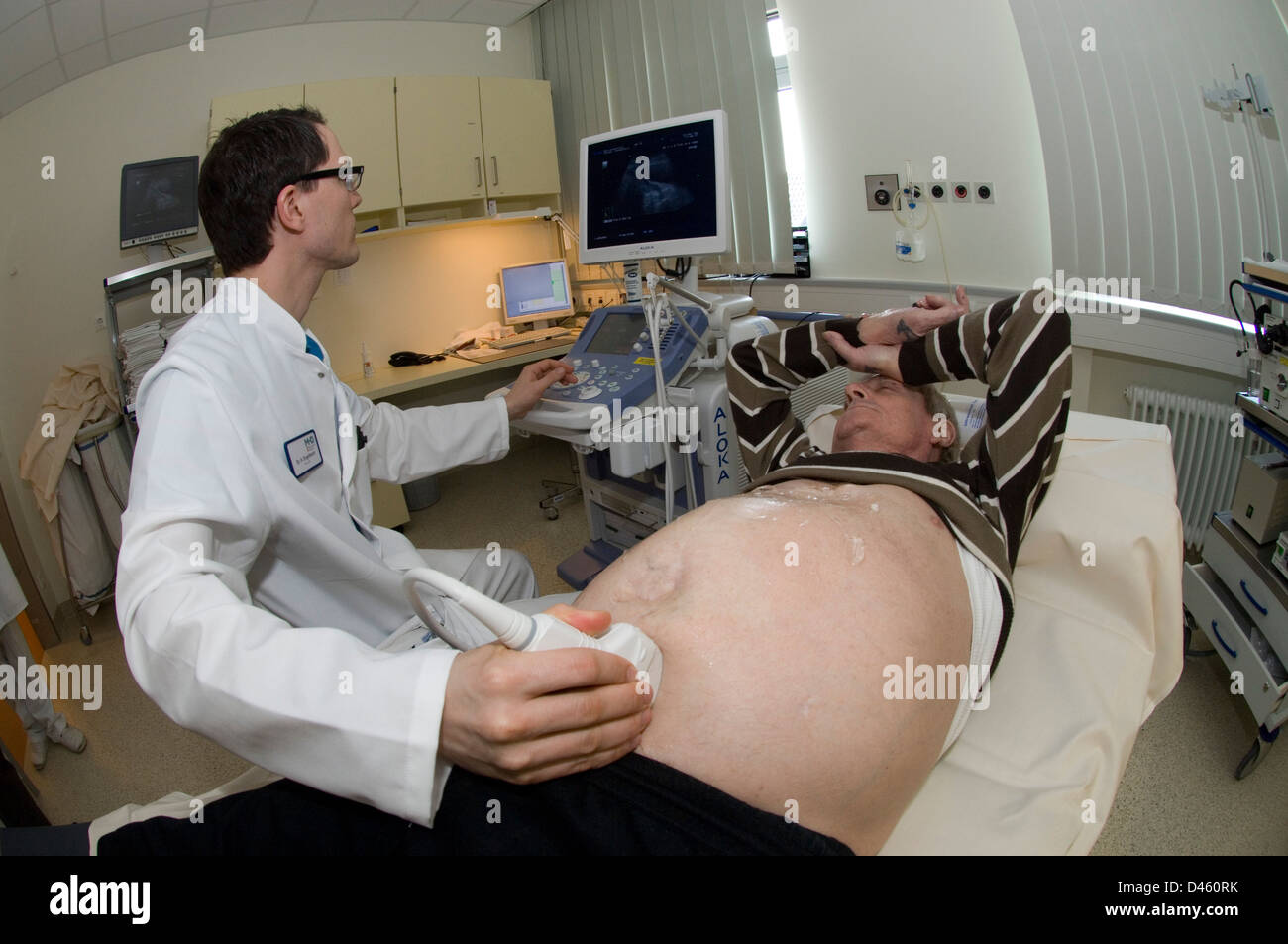 A doctor checks a monitor after performing an endoscopic procedure on a ...
