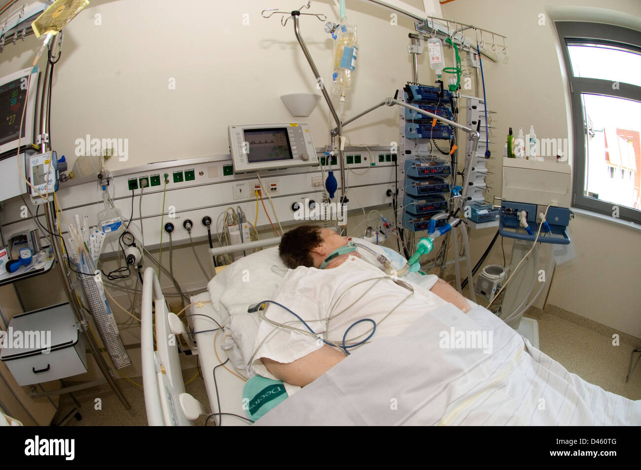 A woman on a life support system in a hospital intensive care unit ...