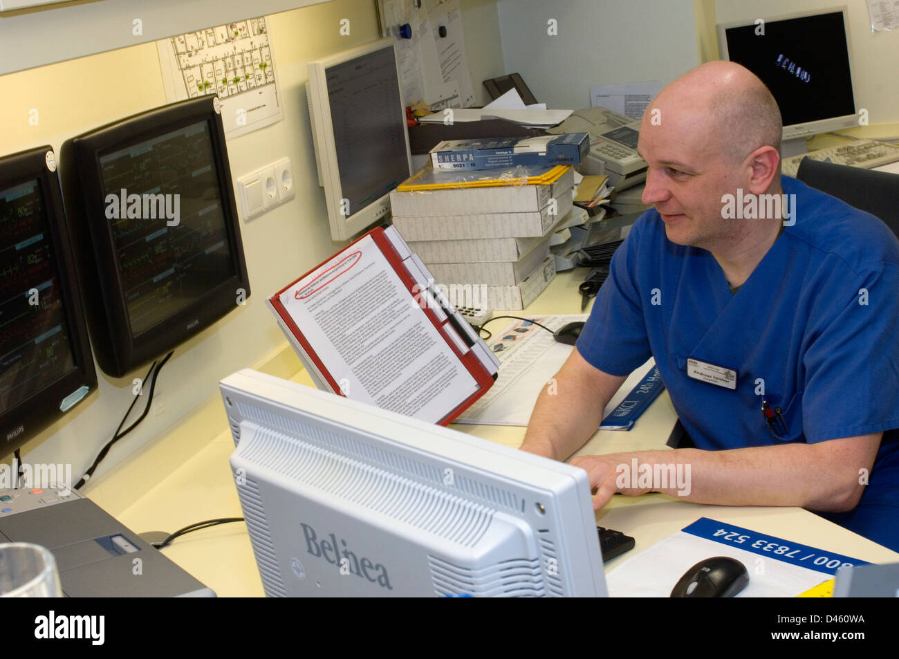 Doctor checking a monitor after performing an endoscropic procedure ...