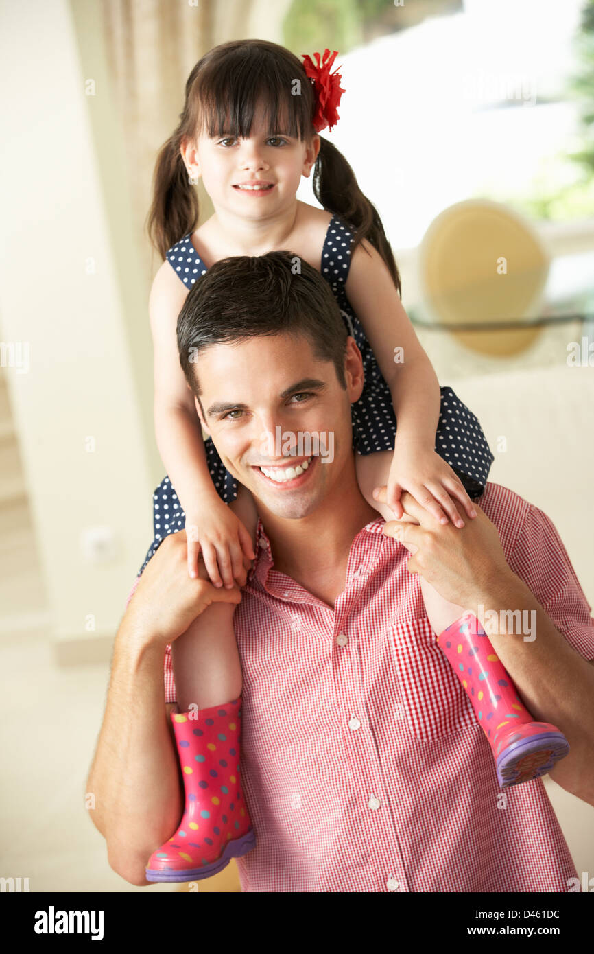 Father Giving Daughter Ride On Shoulders Indoors Stock Photo - Alamy