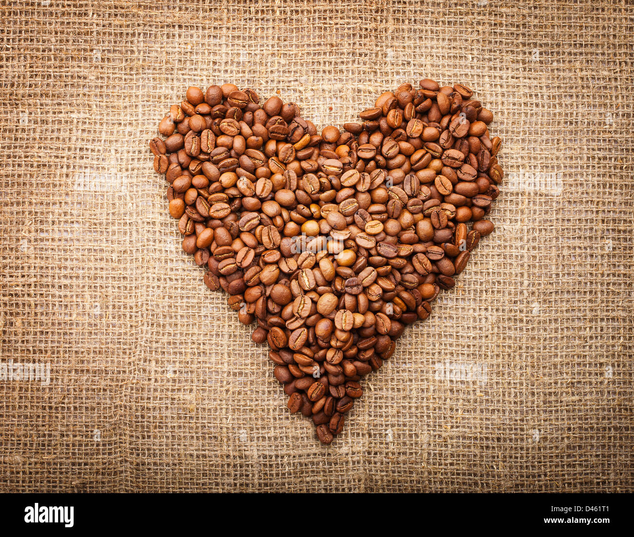 Heart from coffee beans on textured brown sack Stock Photo - Alamy