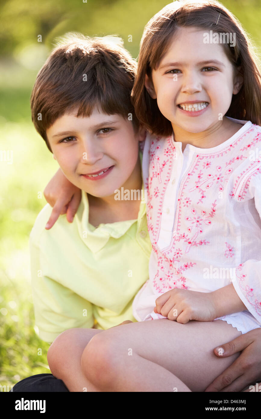 2 Children Giving One Another Hug In Summer Field Stock Photo - Alamy