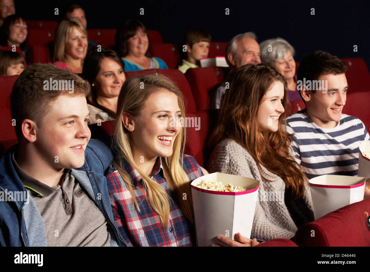Group Of Teenage Friends Watching Film In Cinema Stock Photo - Alamy