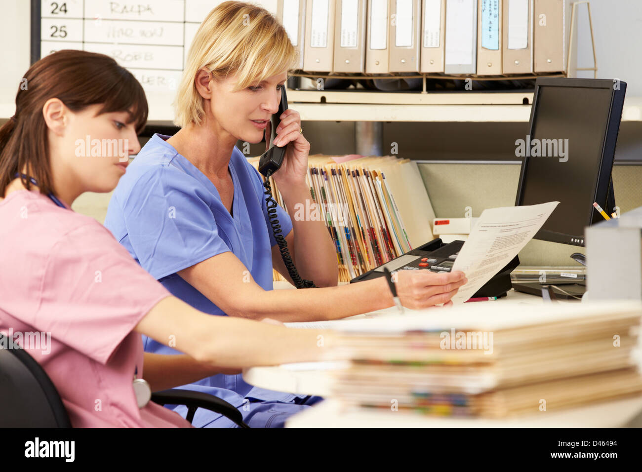 Nurse Using Digital Tablet At Nurses Station Stock Photo - Alamy
