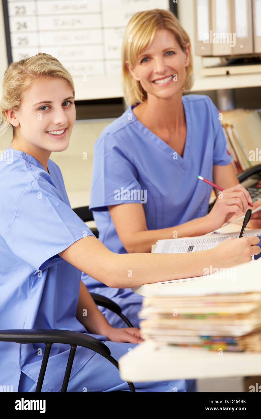 Two Nurses Working At Nurses Station Stock Photo - Alamy