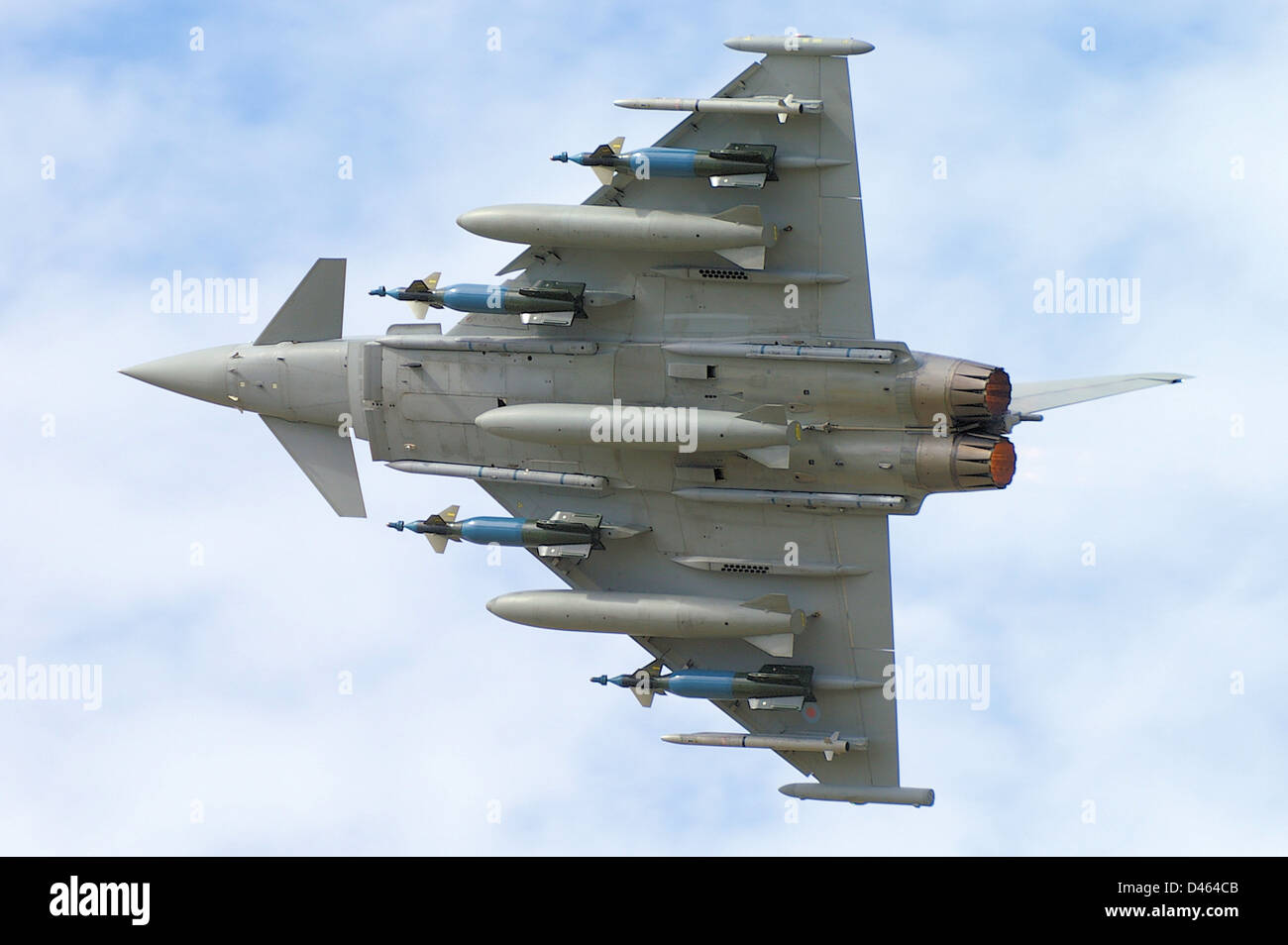 A Eurofighter Typhoon with a full weapons load displays its agility ...