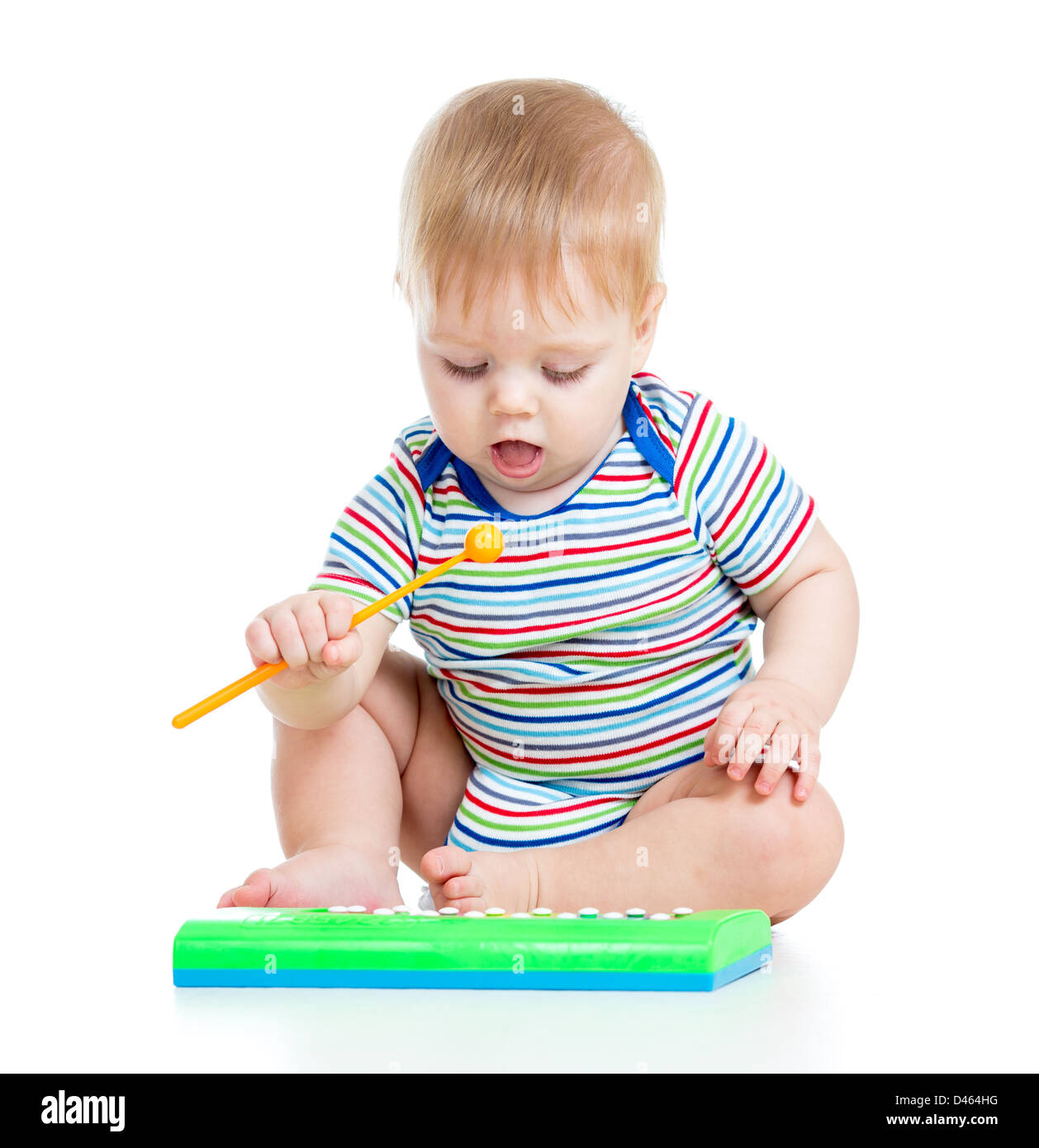 funny baby boy playing with musical toys Stock Photo - Alamy