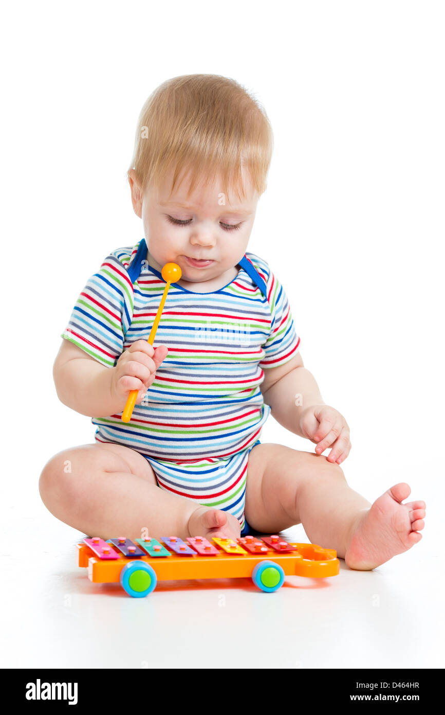 funny baby boy playing with musical toys Stock Photo - Alamy