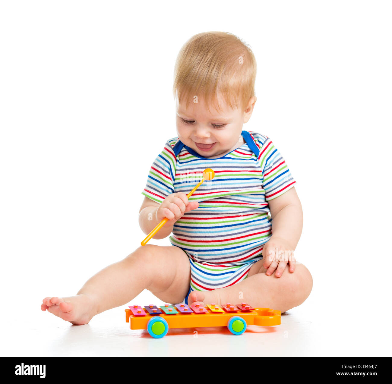 funny baby boy playing with musical toys Stock Photo - Alamy