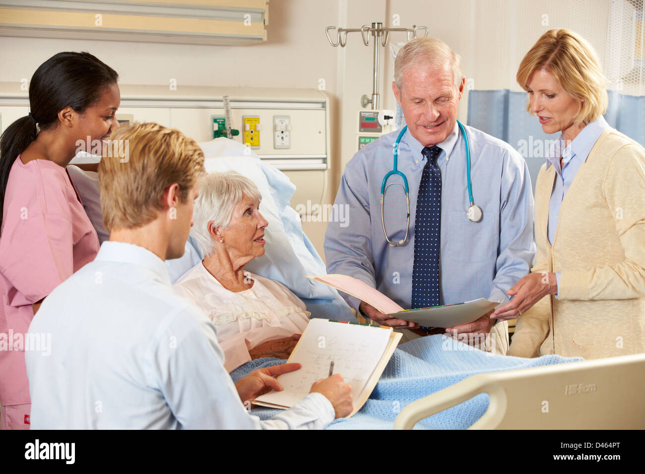 Medical Team Visiting Senior Female Patient In Bed Stock Photo - Alamy