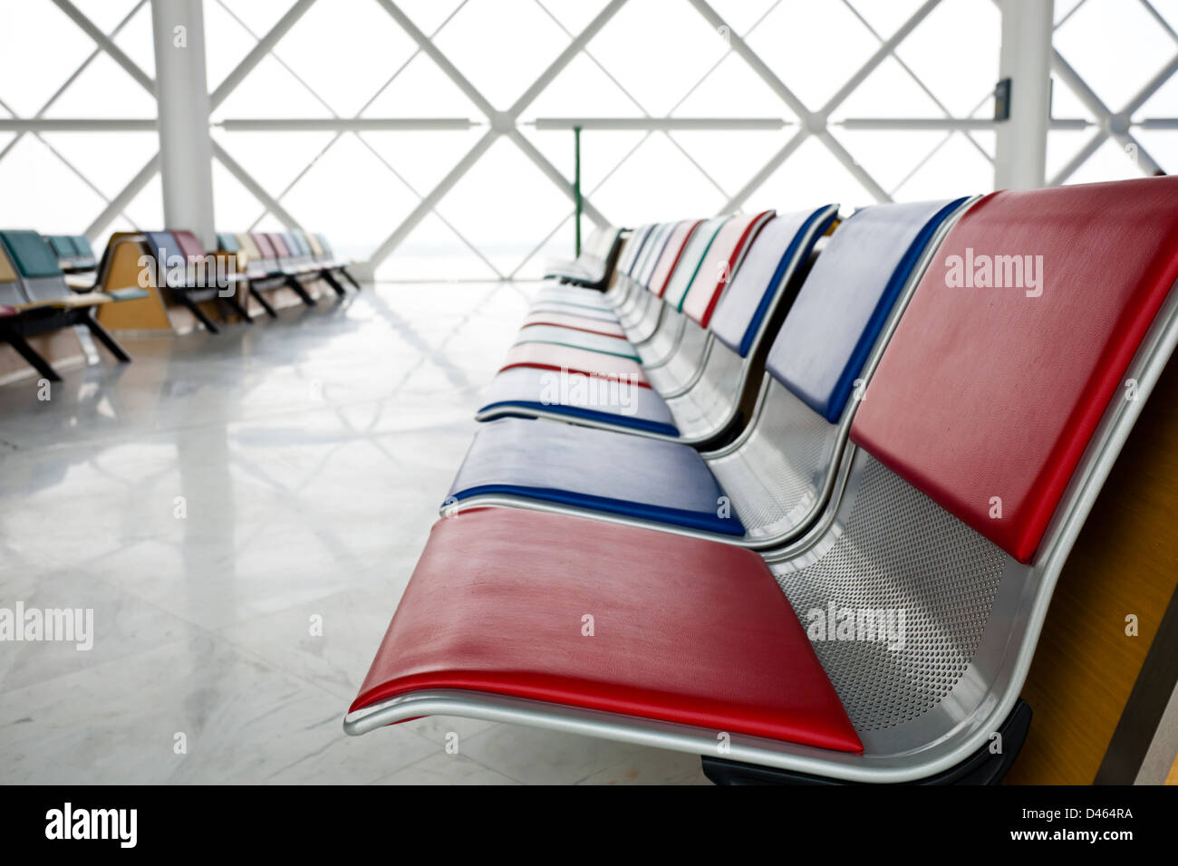 Airport terminal waiting area, rows of colorful seats Stock Photo - Alamy