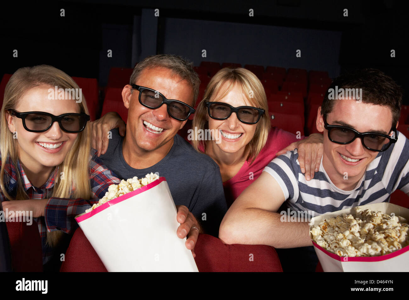 Teenage Family Watching Film In Cinema Stock Photo - Alamy