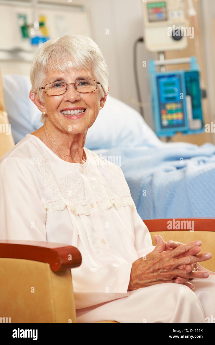 Portrait Of Senior Female Patient Seated In Chair By Hospital Bed Stock ...