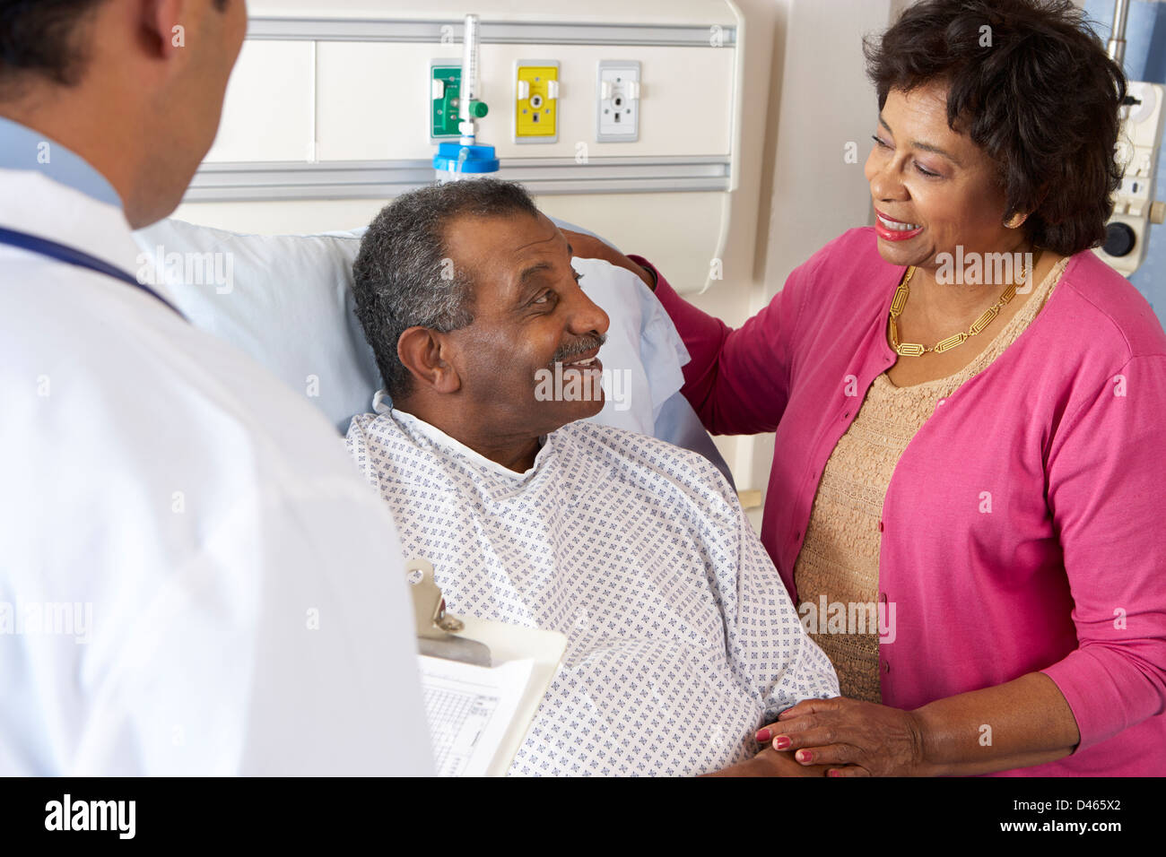 Doctor talking couple on ward hi-res stock photography and images - Alamy