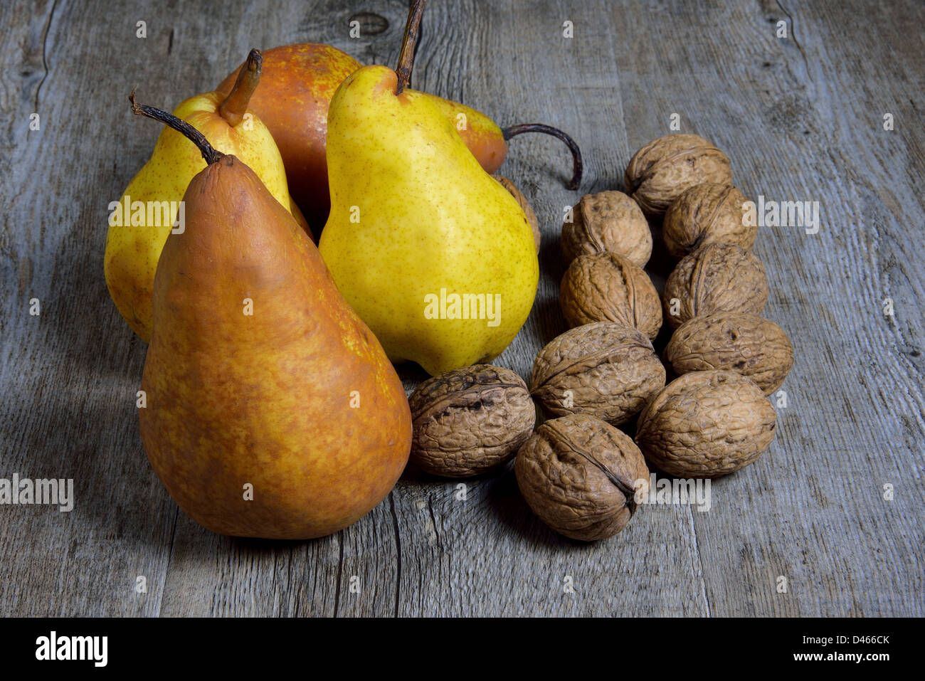 pears and nut on wooden table Stock Photo - Alamy