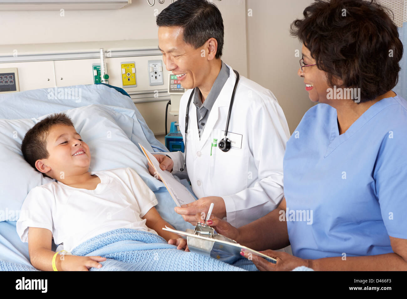 Doctor And Nurse Visiting Child Patient On Ward Stock Photo - Alamy