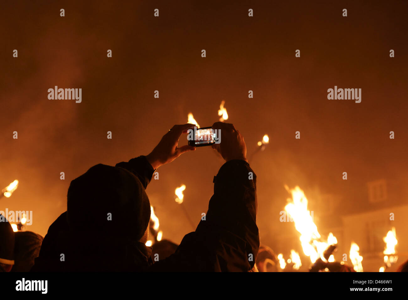 Battle bonfire man taking photo with an iPhone smartphone cell phone of ...