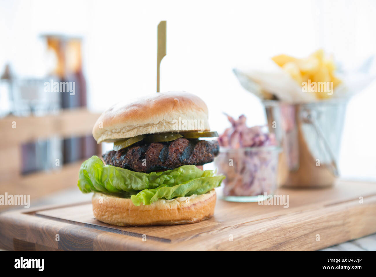 Beef burger in a bun, served with chips Stock Photo - Alamy