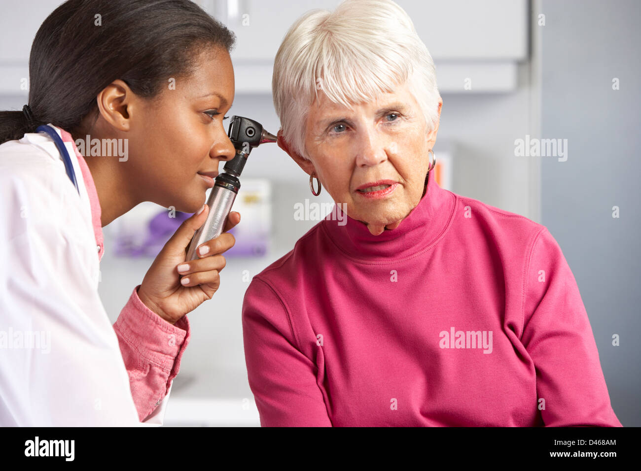 Doctor check ear female african senior hi-res stock photography and ...