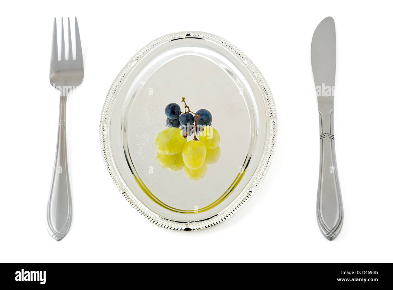 Some berries of a grape lay on a silver plate Stock Photo - Alamy