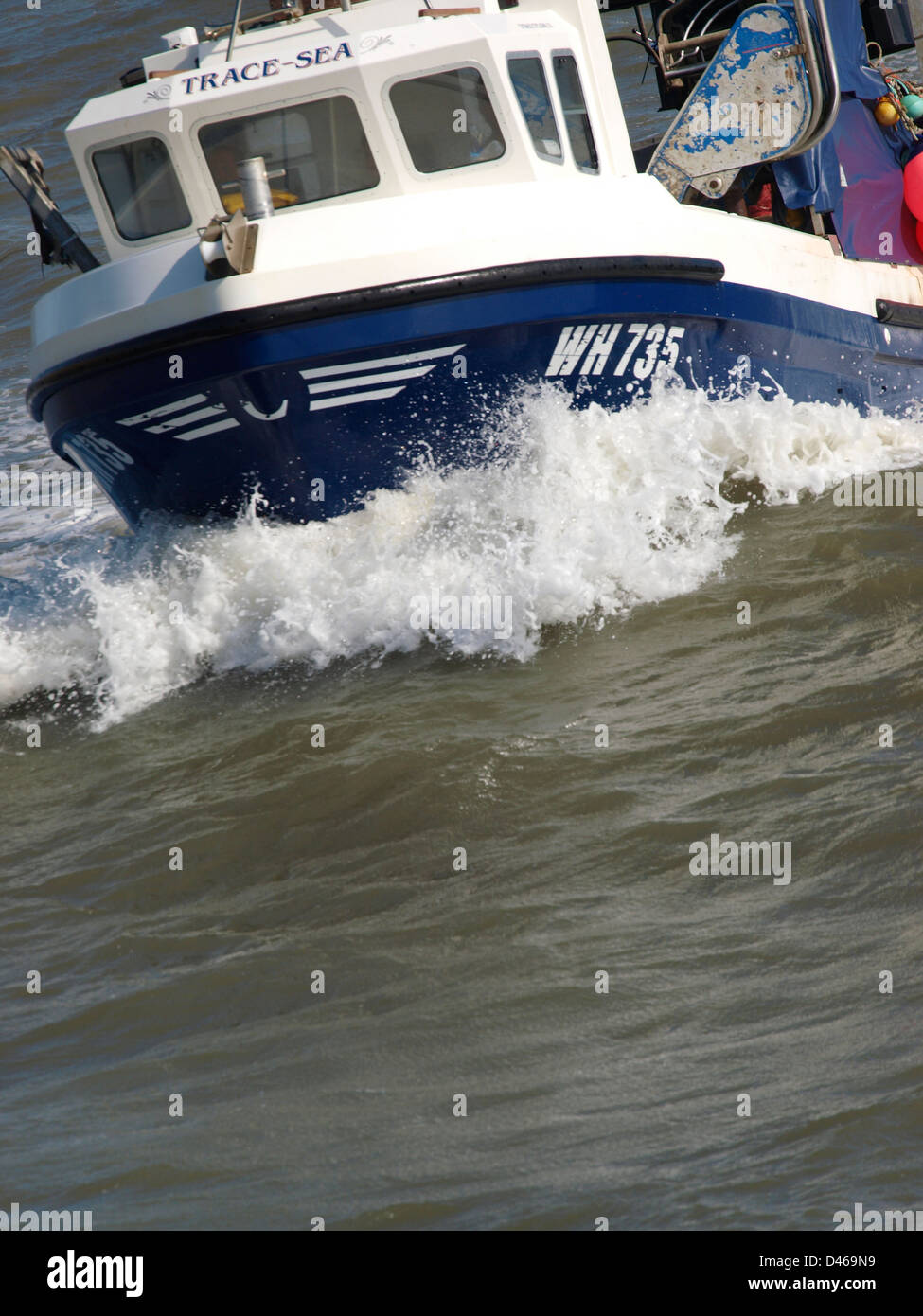 Fishing boat pushing through sea water at speed Stock Photo - Alamy