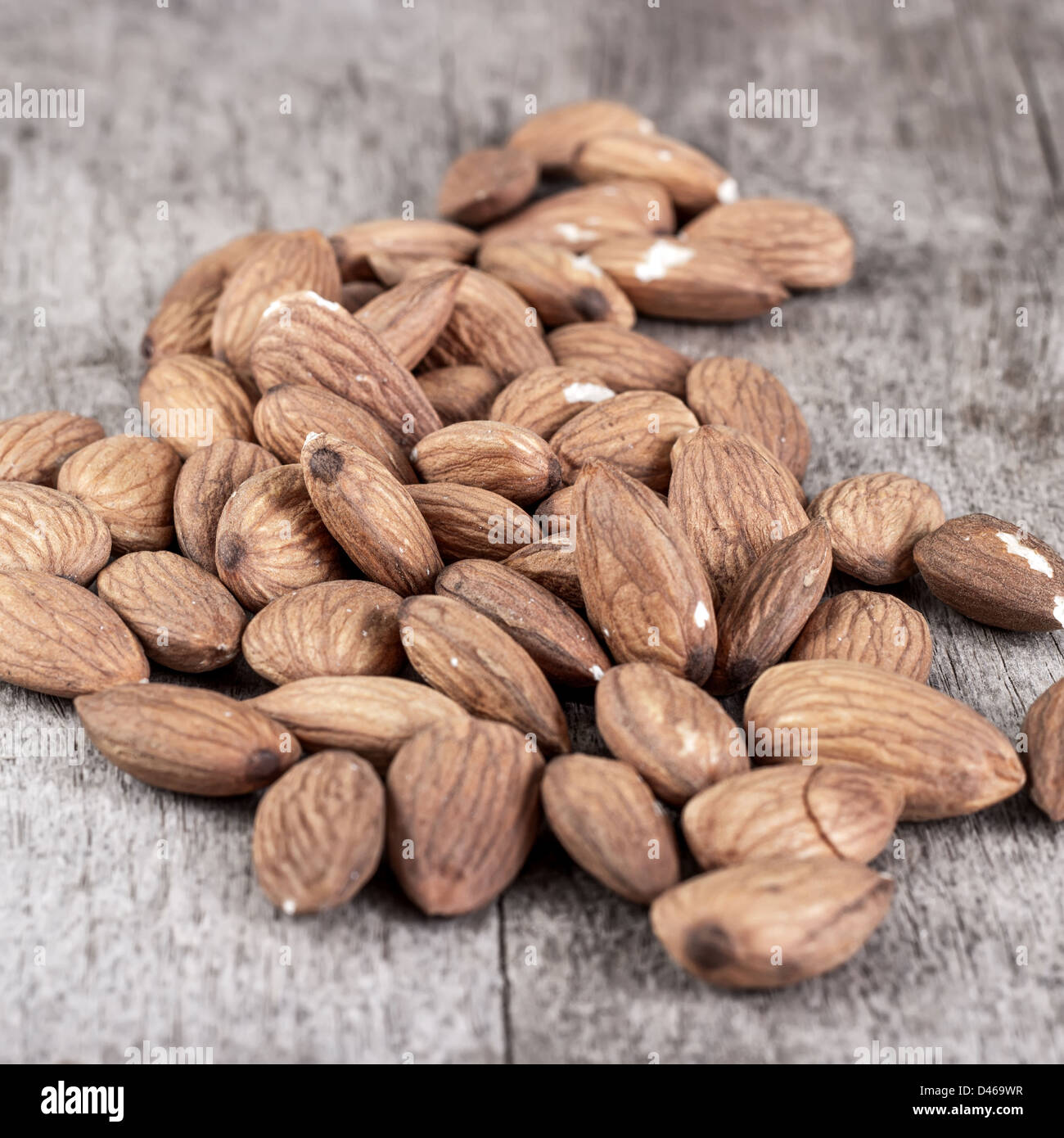 roasted almonds on wooden table, food background Stock Photo - Alamy