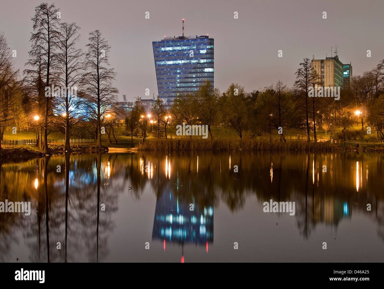 Night scenery of tower building facing a lake Stock Photo - Alamy